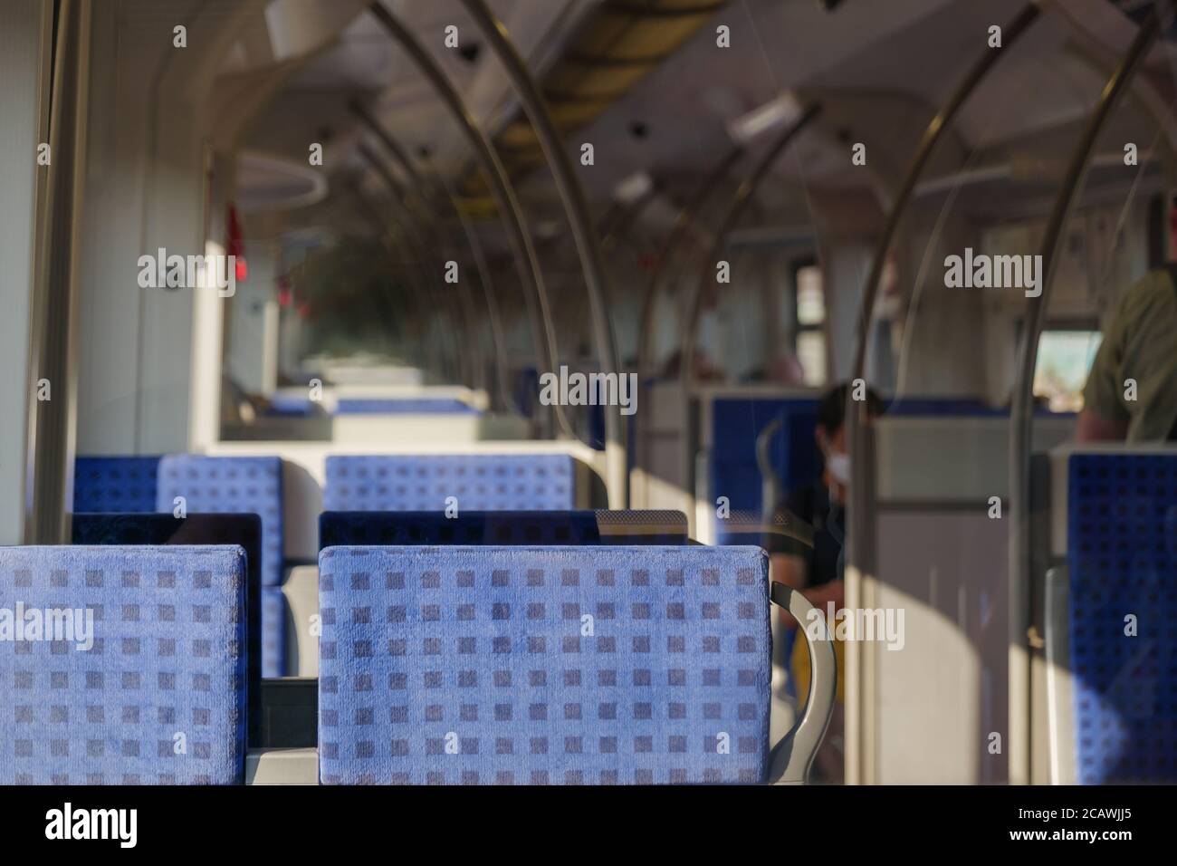 Interior view of a corridor inside passenger trains with blue fabric ...