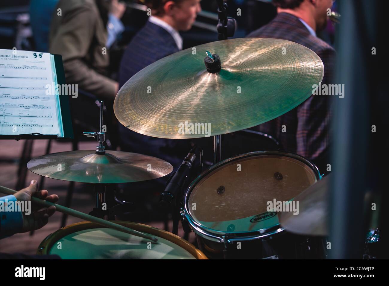 Drummer percussionist performing on a stage with drum set kit during ...