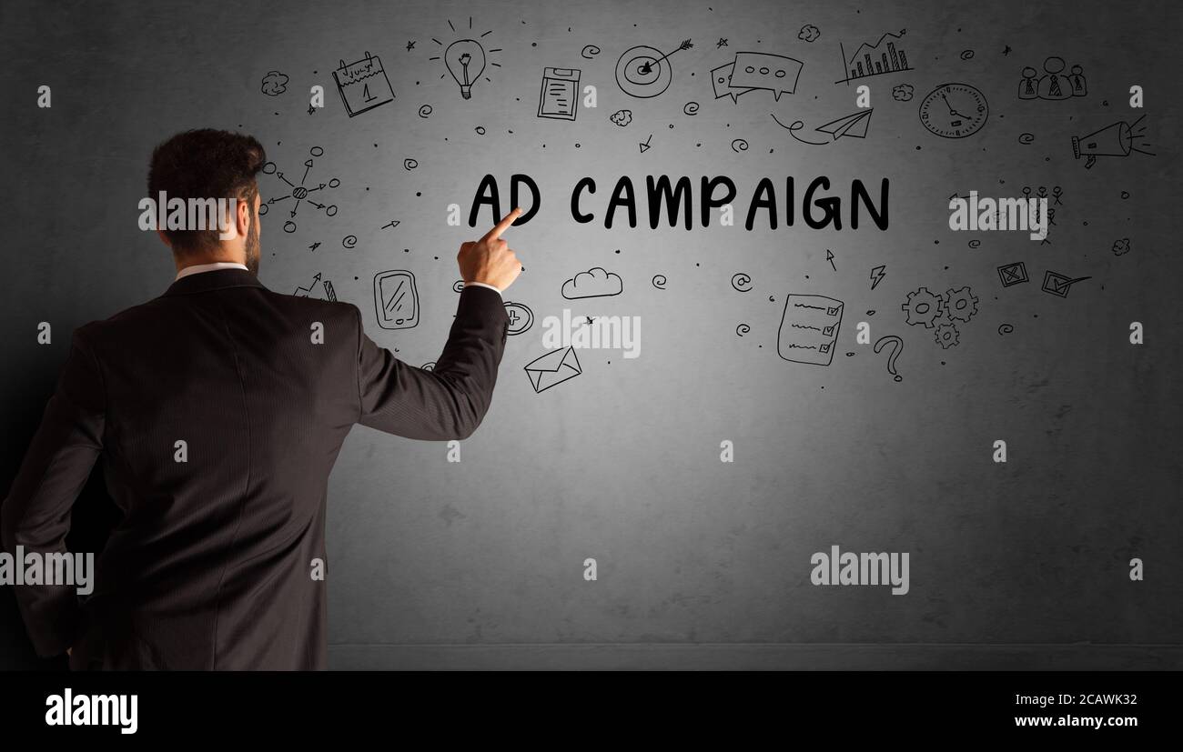 businessman drawing a creative idea sketch with AD CAMPAIGN inscription ...