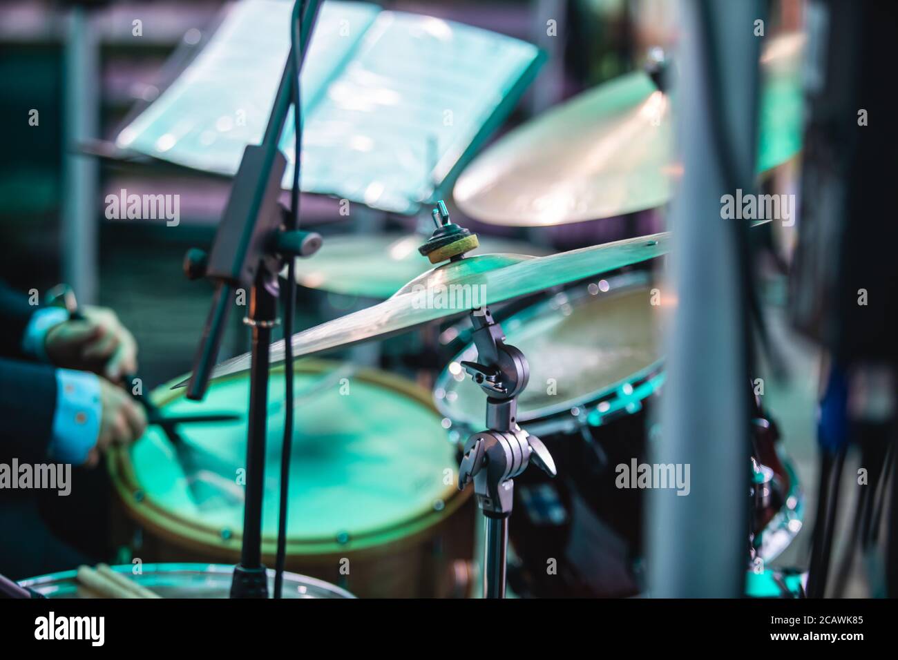 Drummer percussionist performing on a stage with drum set kit during ...