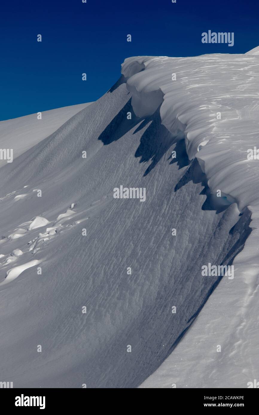 Vertical shot of mountain summit covered with white snow in the winter ...