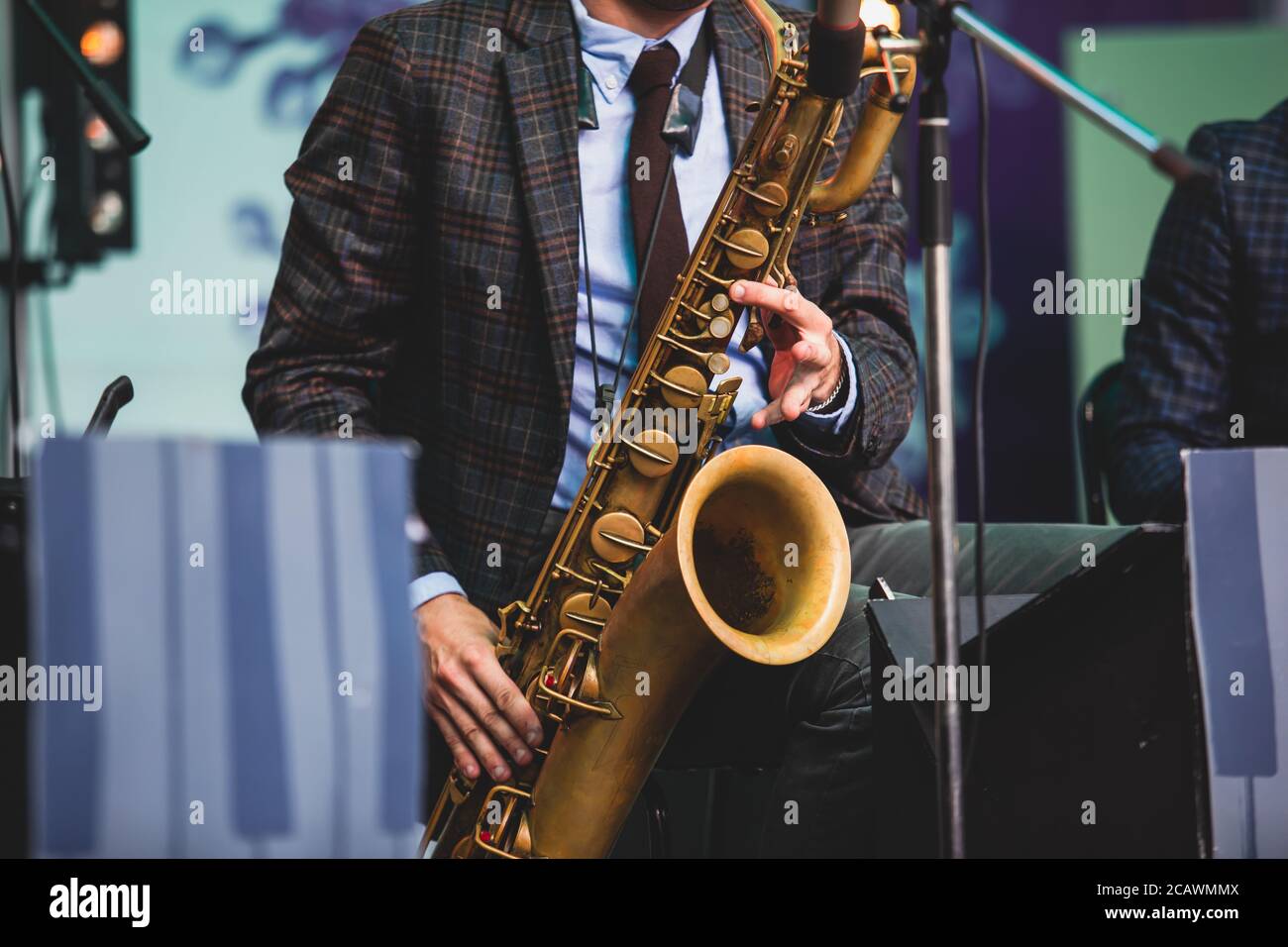 Concert view of a saxophonist, saxophone sax player with vocalist and ...