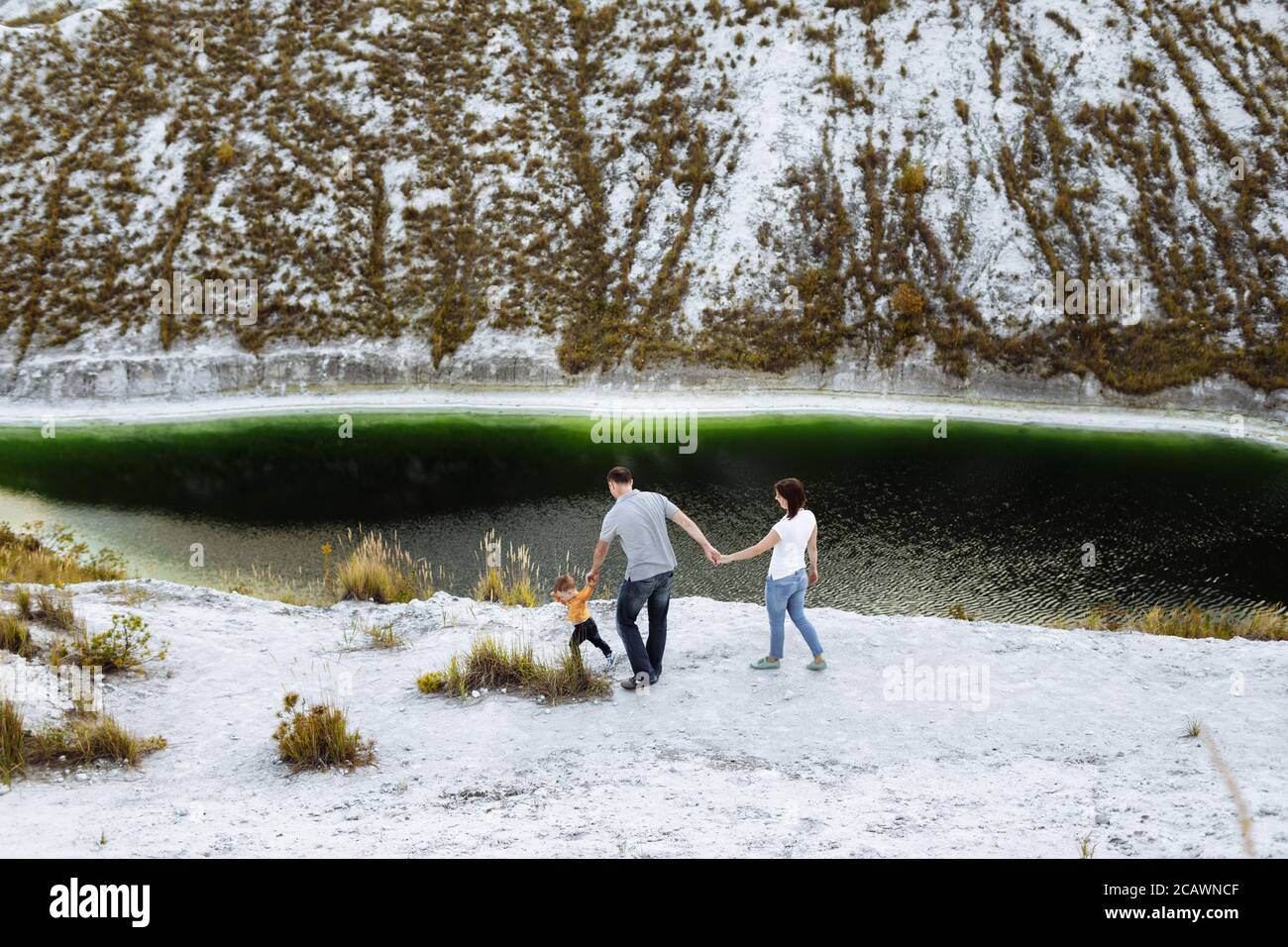 Happy young family near lake, pond. Family enjoying life together at ...