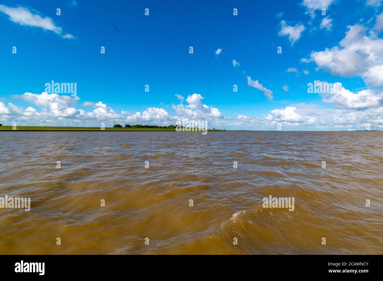 Low angle shot of a brown water lake on a cloudy day Stock Photo - Alamy