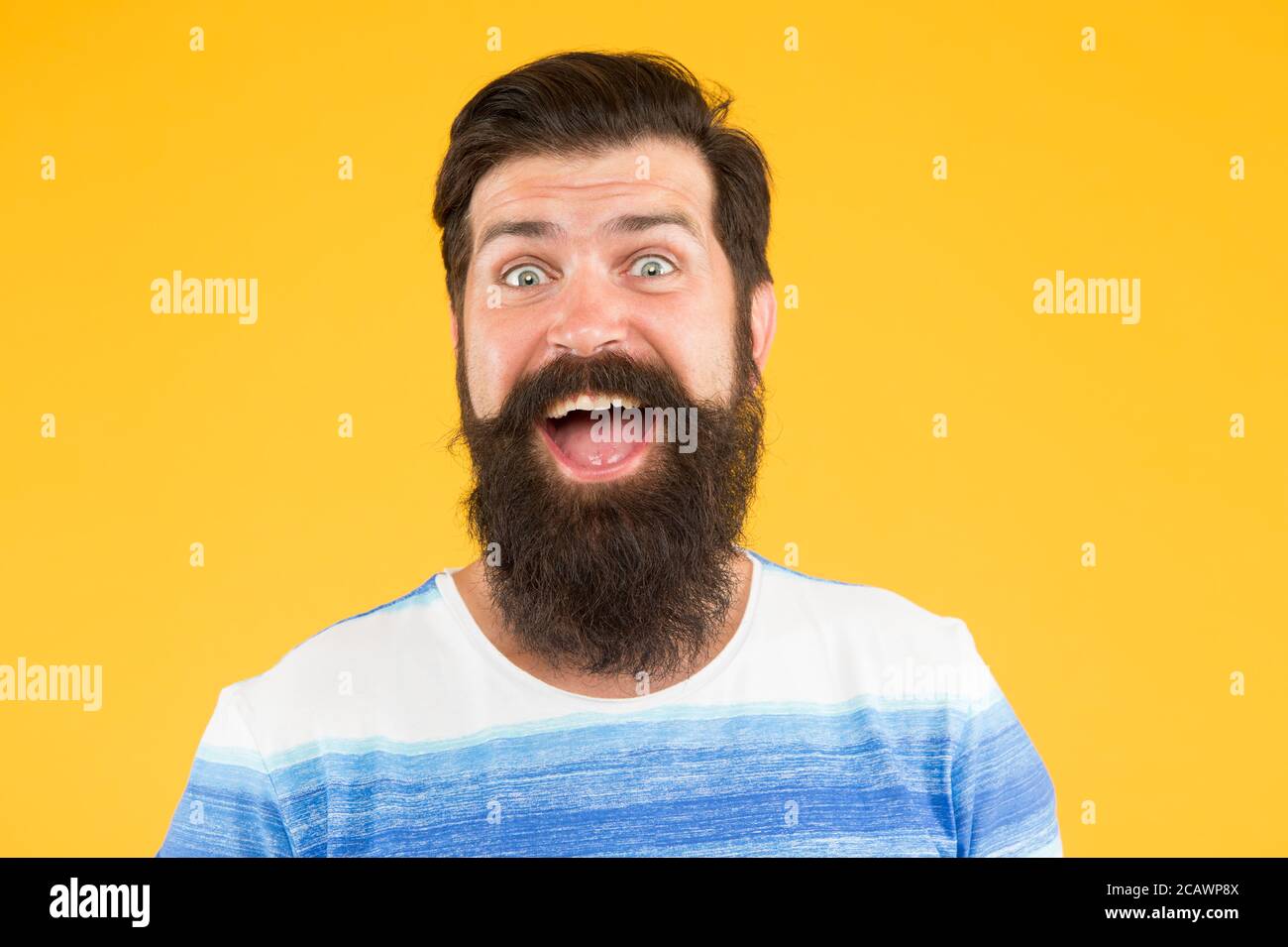 Real surprise. Man bearded stylish beard yellow background. Barber tips ...