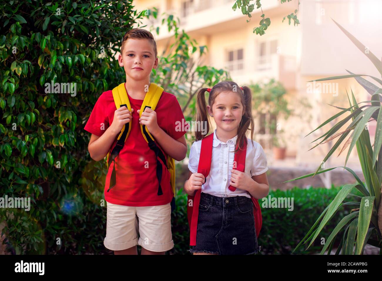 Back to school. Pupils with backpacks staying outdoor Stock Photo - Alamy