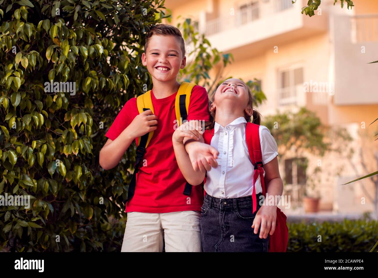 Back to school. Pupils with backpacks staying outdoor Stock Photo - Alamy