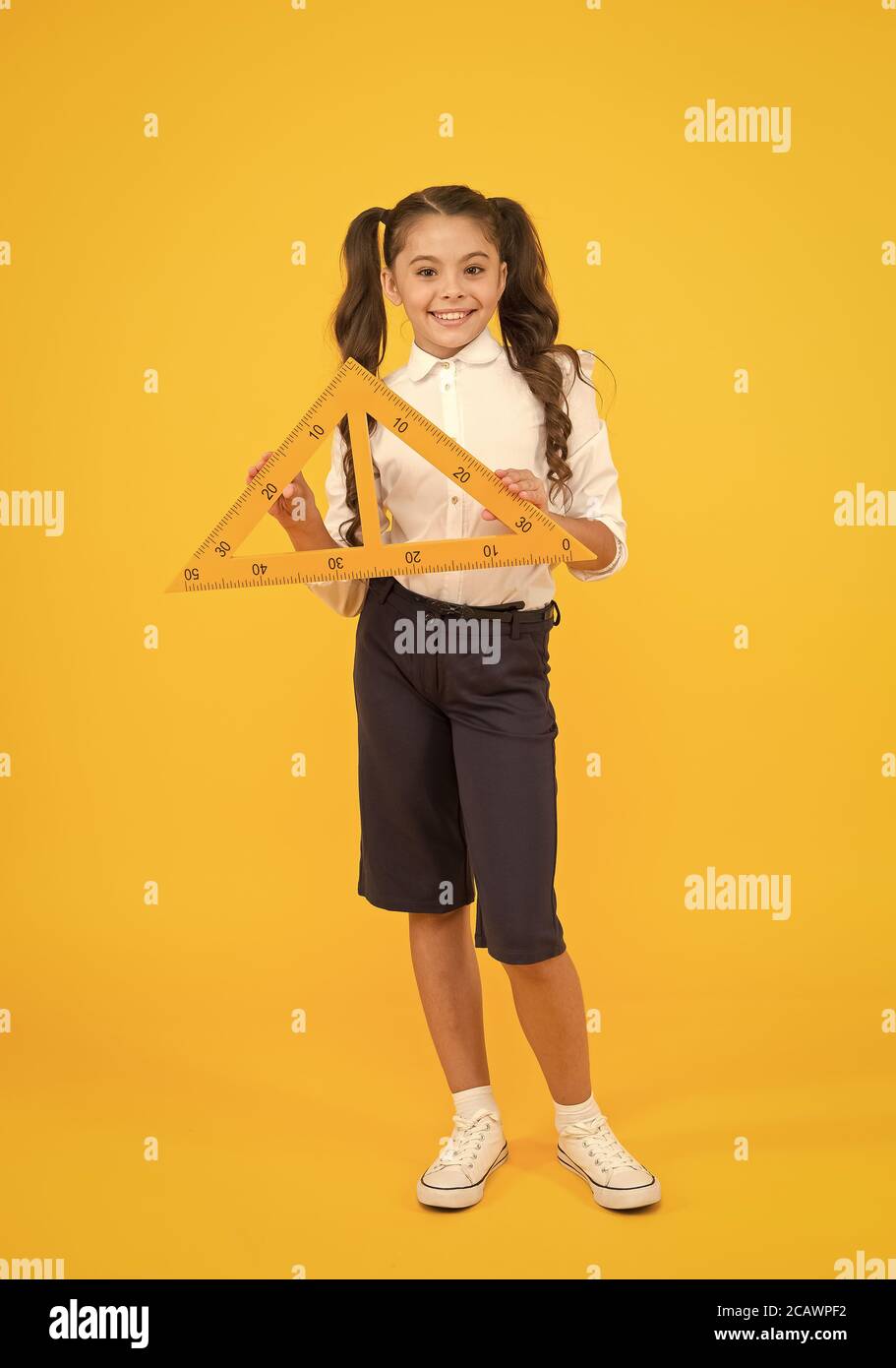 Schoolgirl school uniform hold big ruler geometry school lesson. Math ...