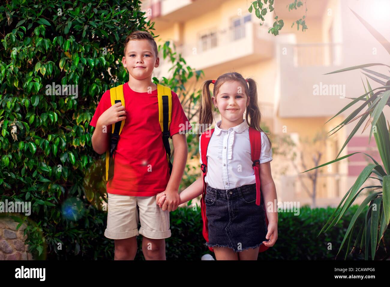 Back to school. Pupils with backpacks staying outdoor Stock Photo - Alamy
