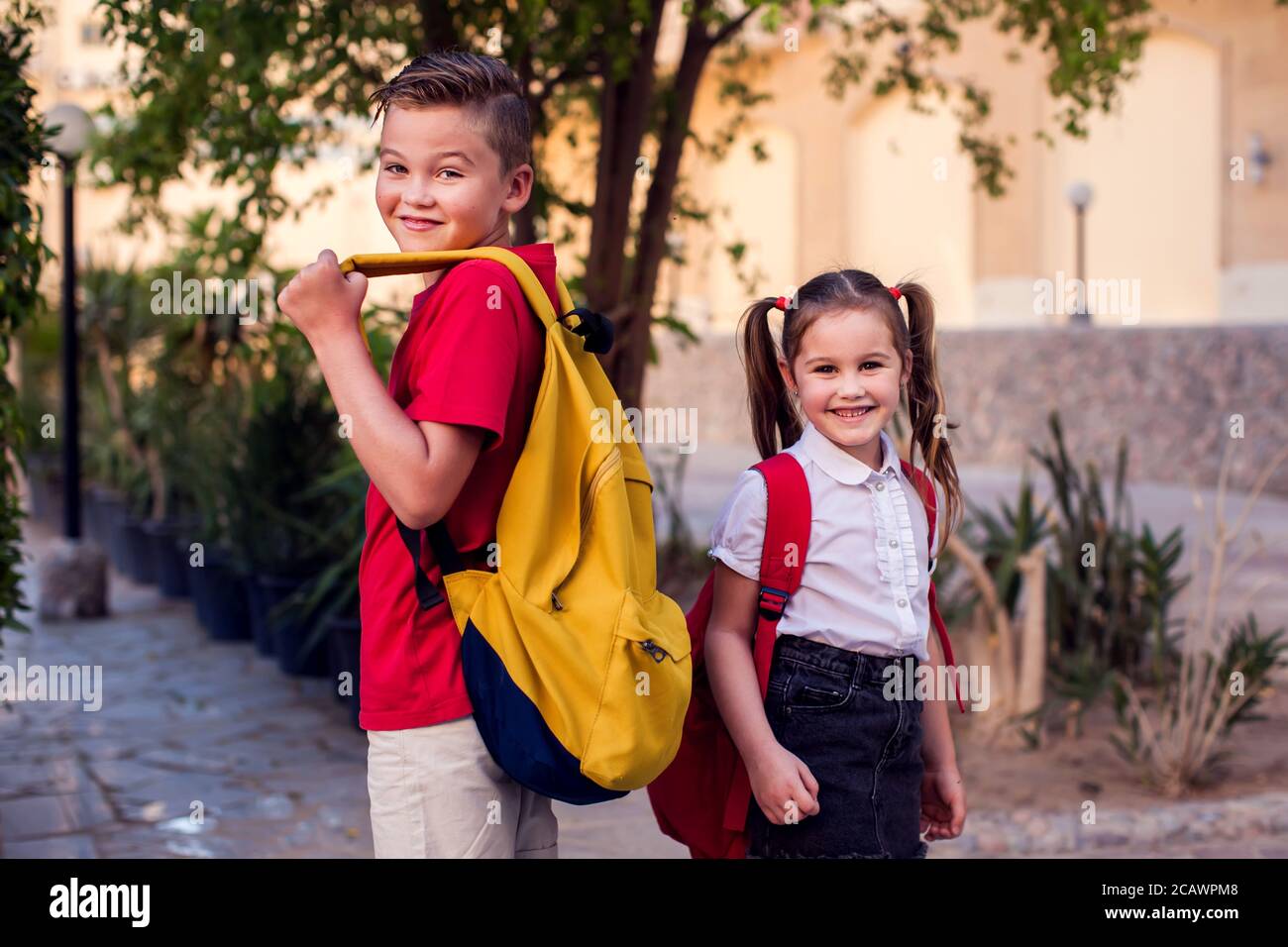 Back to school. Pupils with backpacks staying outdoor Stock Photo - Alamy