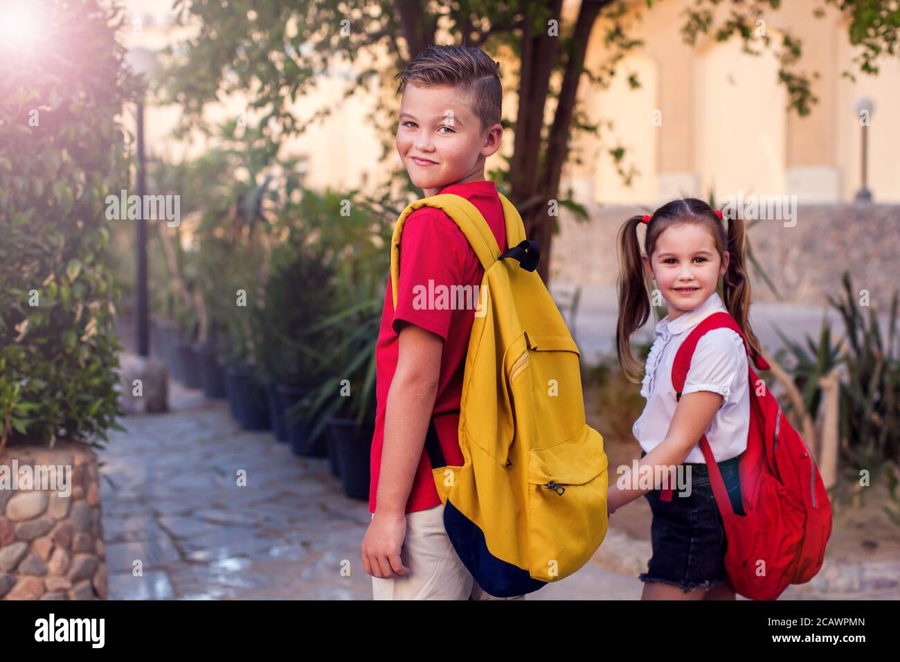 Back to school. Pupils with backpacks staying outdoor Stock Photo - Alamy
