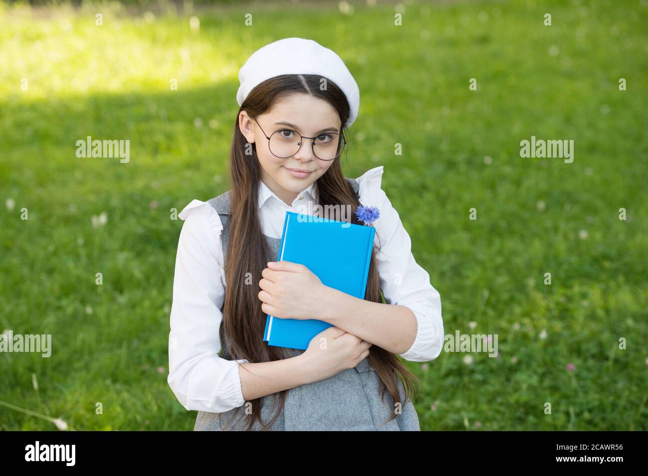 Elegant schoolgirl child girl study with book in park, learning concept ...