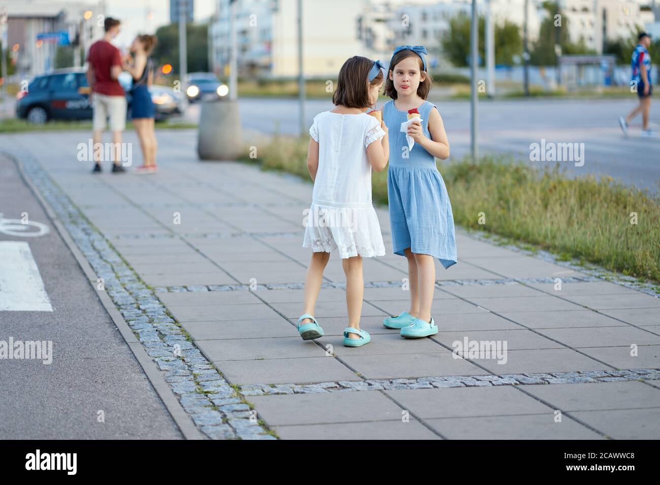 two cute little girls walk around the city and eat ice cream Stock ...