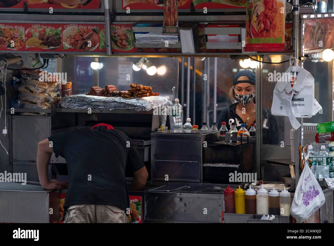 August 08, 2020: A customer wearing a face mask waits for her food from ...
