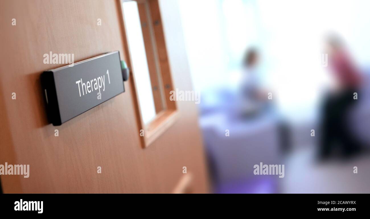 An out of focus therapy session with an open door labeled Therapy 1 ...