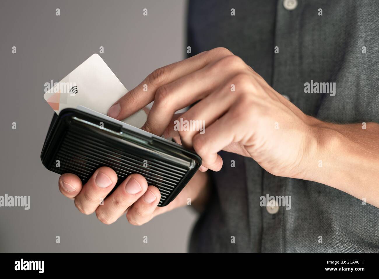Man holding contactless credit card in a wallet with RFID protection ...