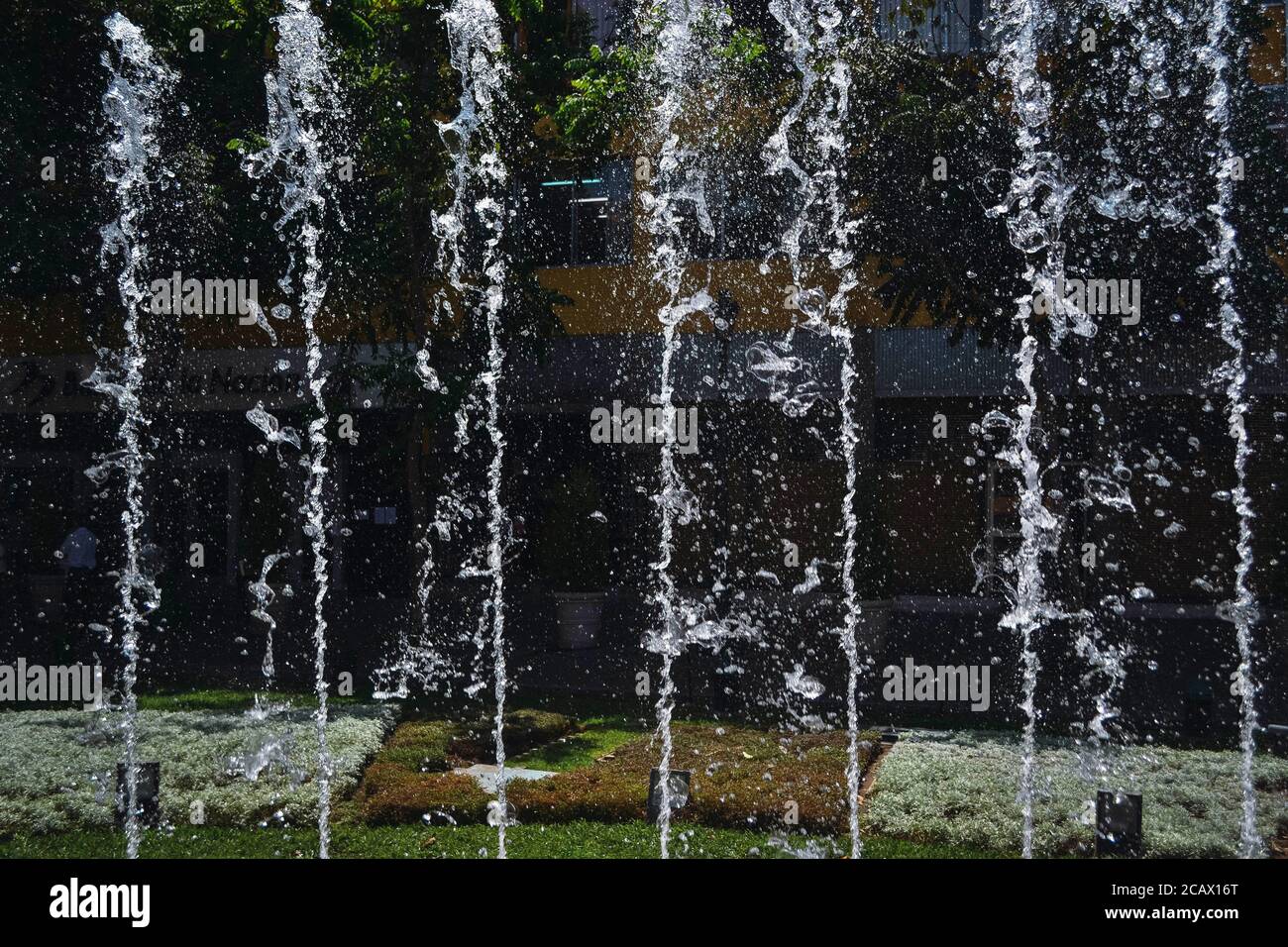 Closeup of a water fountain shooting water upwards outdoors during ...