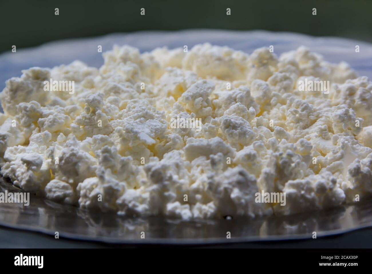 Lumps of fresh delicious cottage cheese for breakfast Stock Photo - Alamy