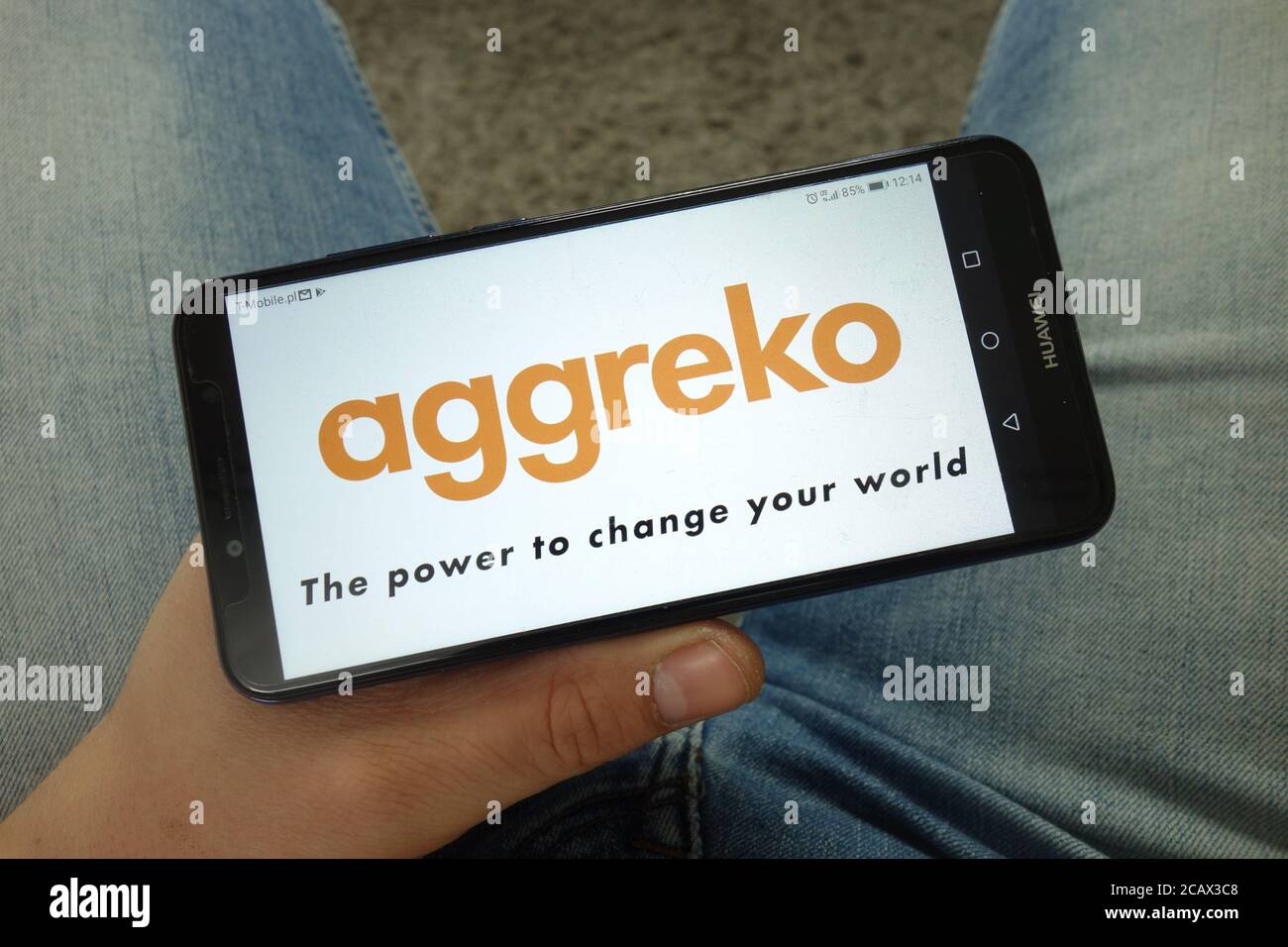 Man holding smartphone with Aggreko plc company logo Stock Photo - Alamy