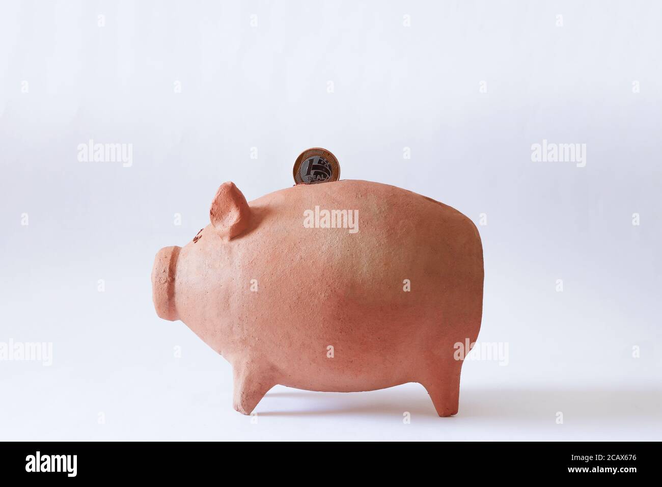 Pig coin with Brazilian money and coins Stock Photo - Alamy