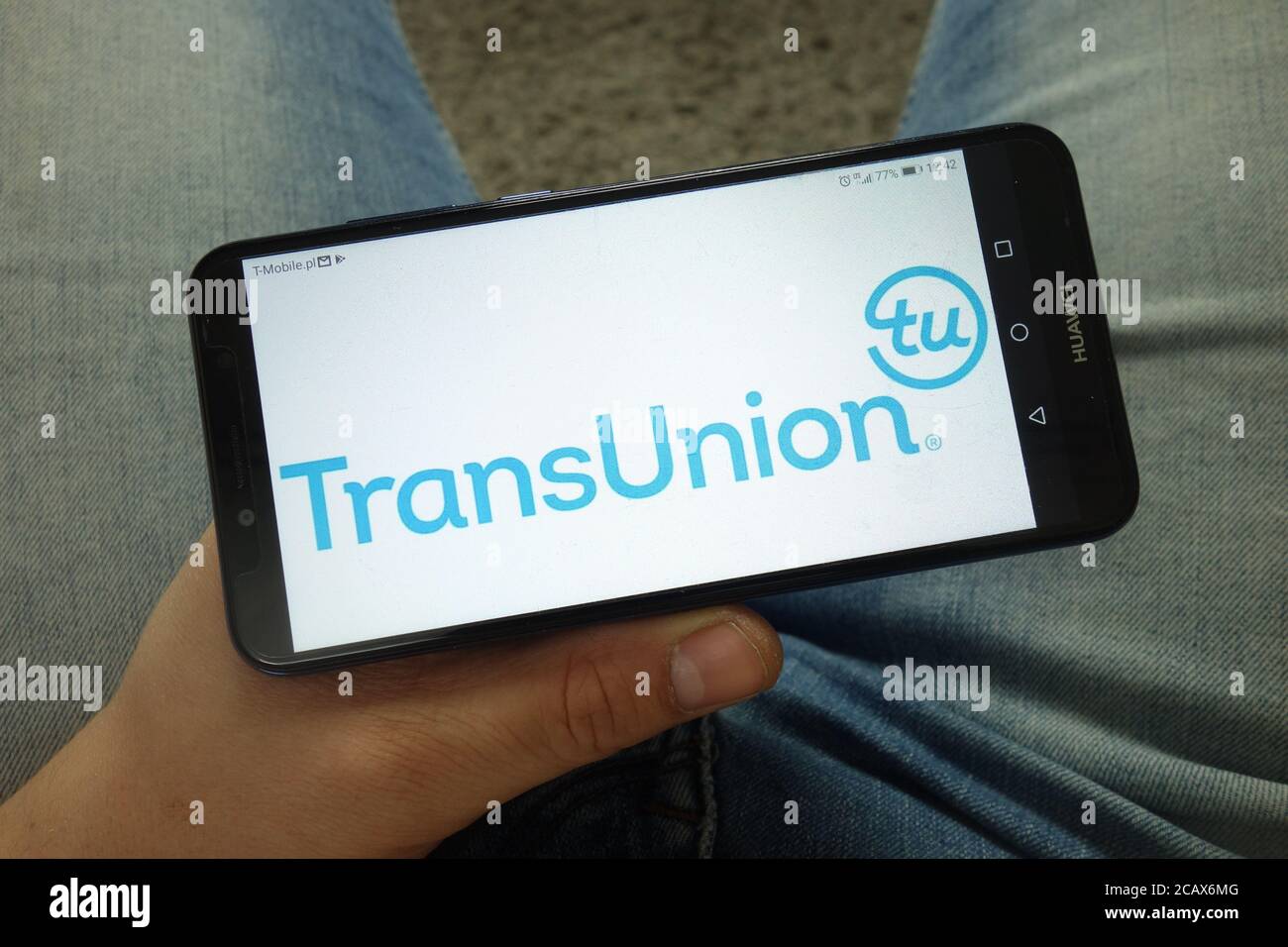 Man holding smartphone with TransUnion American consumer credit ...