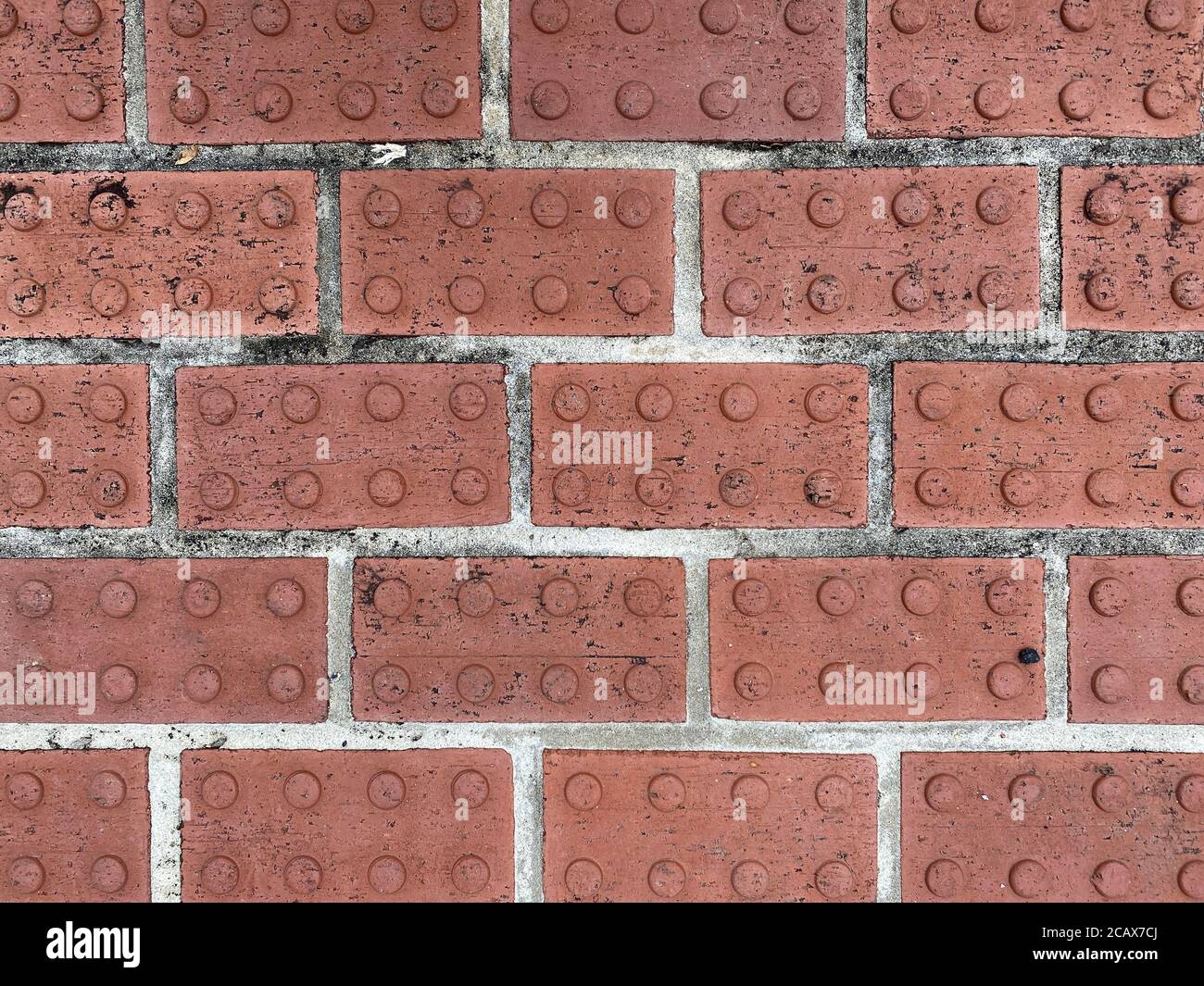 red raised circular close-up vintage pattern brick pave, rich colors ...