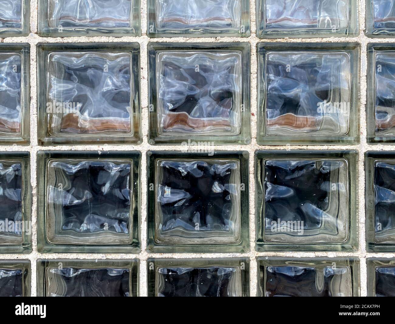 vintage close-up view wavy texture glass brick window wall, faded white ...