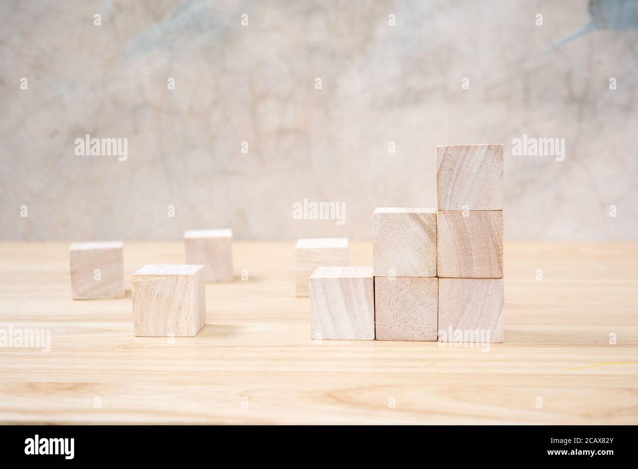 Wooden toy cubes on wooden table ang grey background Stock Photo - Alamy