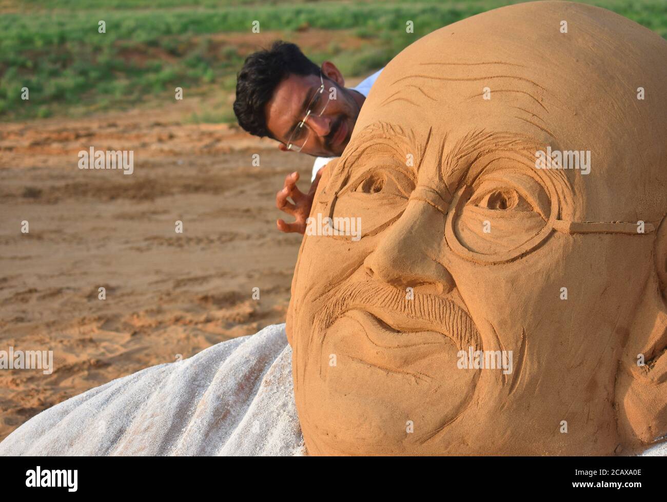 Pushkar, Rajasthan, India, Aug 9, 2020: Sand artist Ajay Rawat gives a ...