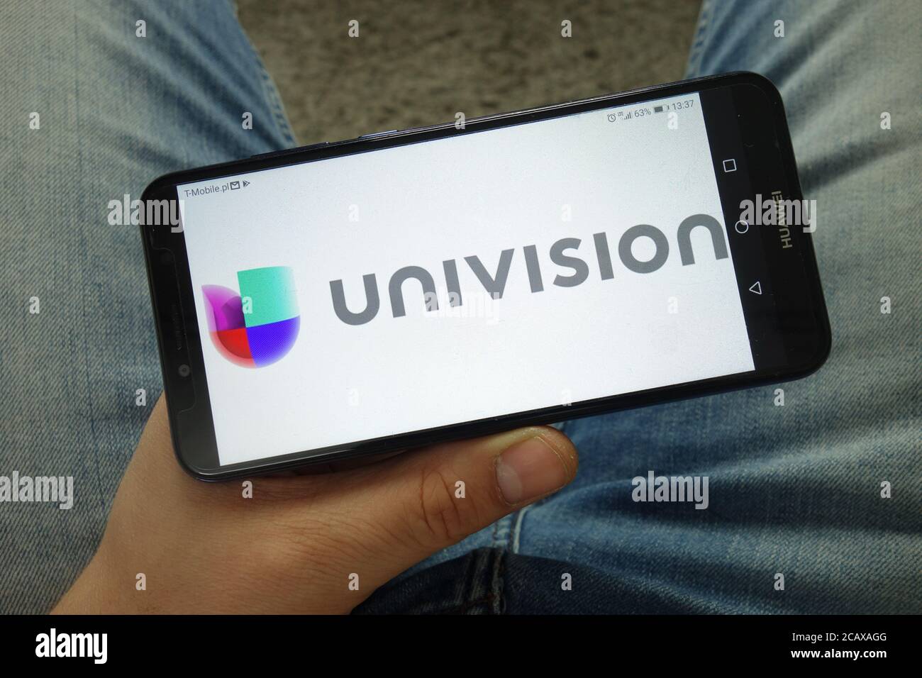 Man holding smartphone with Univision television network logo Stock ...