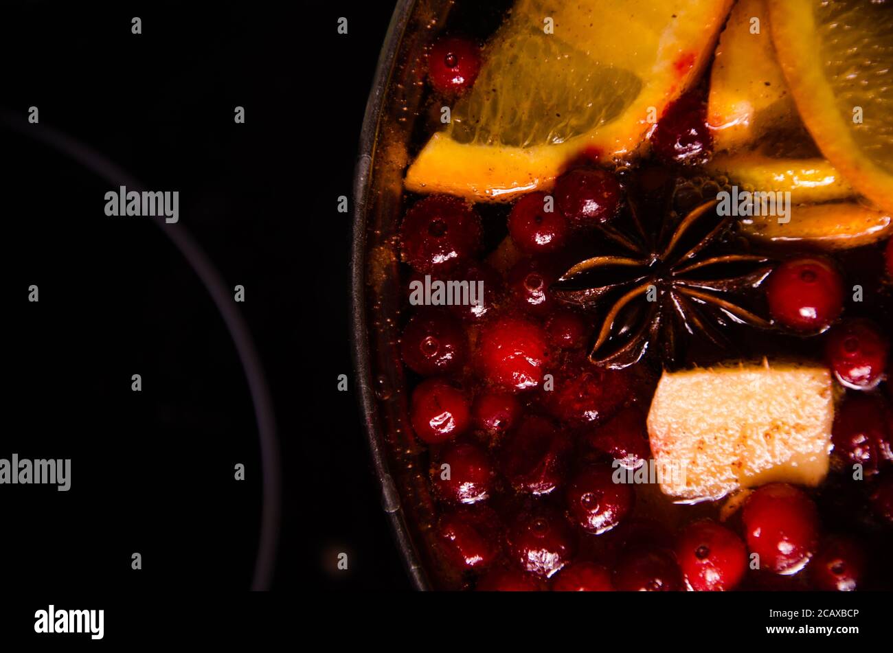 metal pot on the stove. Oranges and cranberries in mulled wine Stock ...