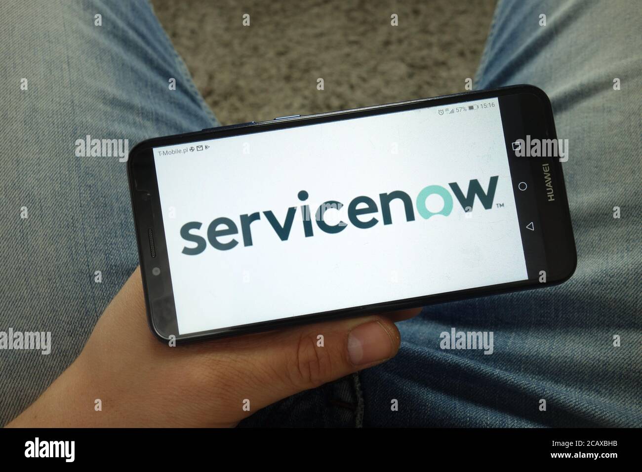 Man holding smartphone with ServiceNow, Inc. company logo Stock Photo ...