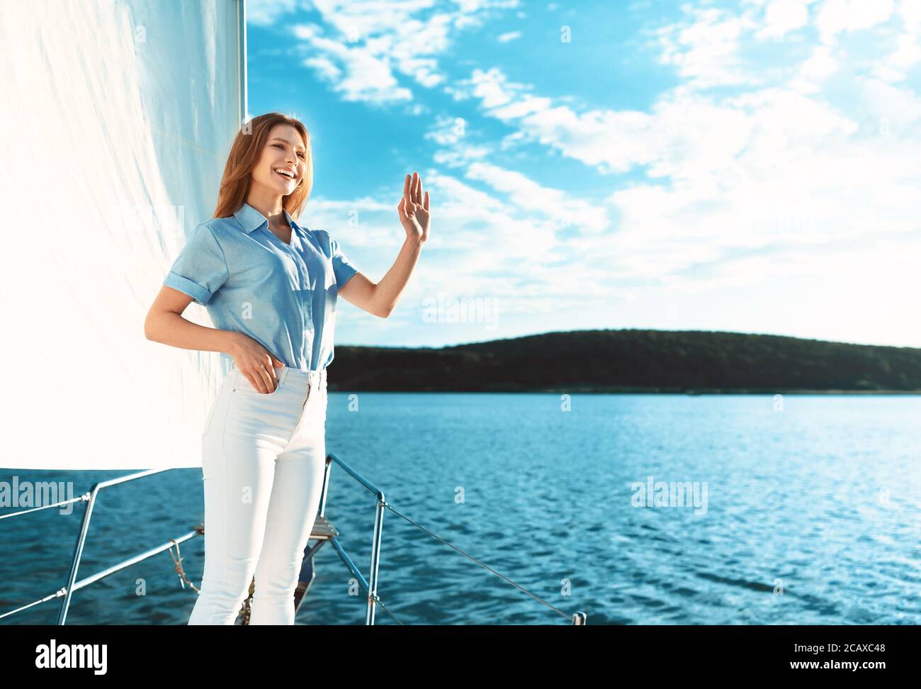 Girl Standing On Yacht Waving Hello Enjoying Sailboat Ride Outdoor ...