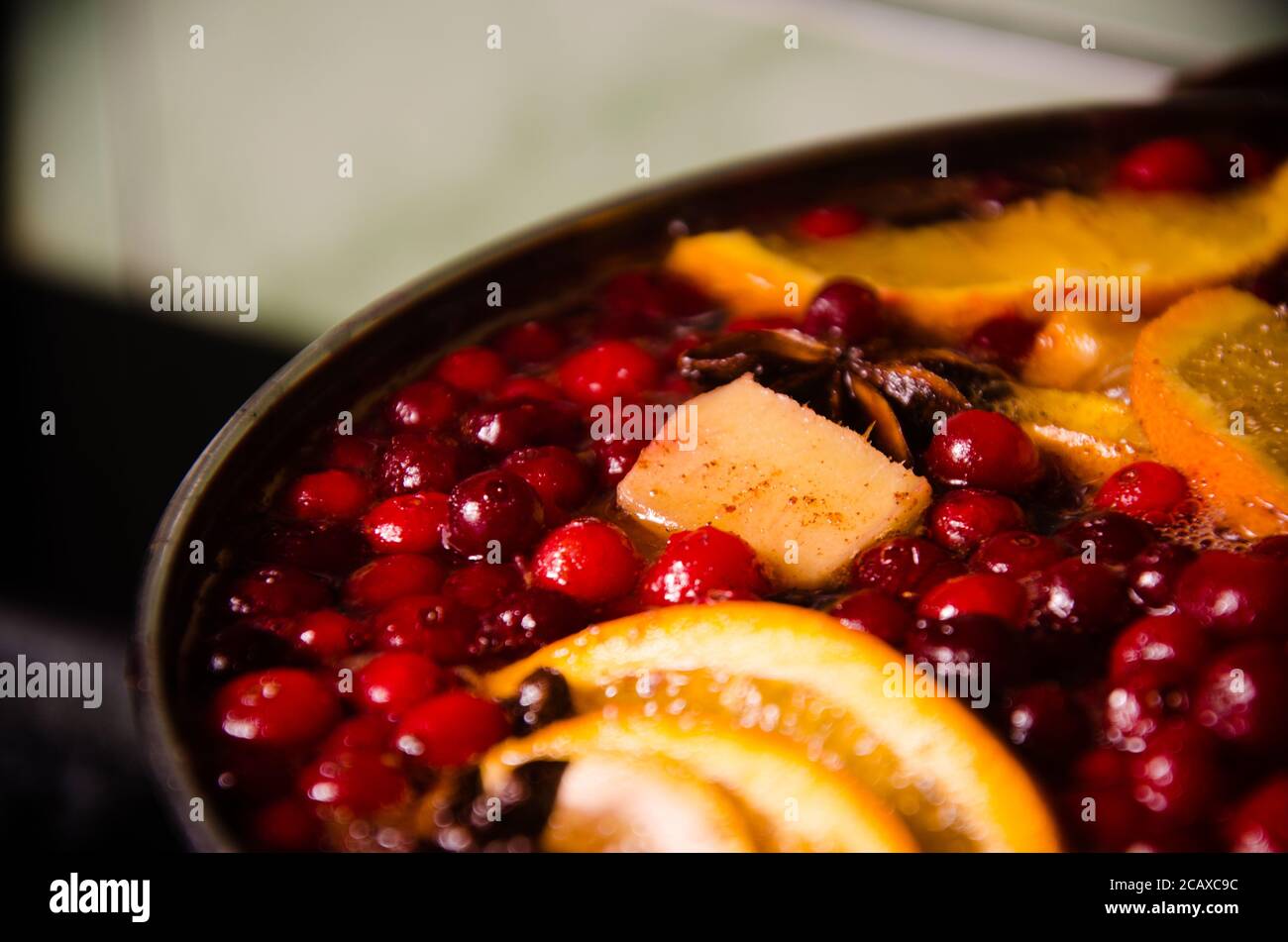 metal pot on the stove. Oranges and cranberries in mulled wine Stock ...