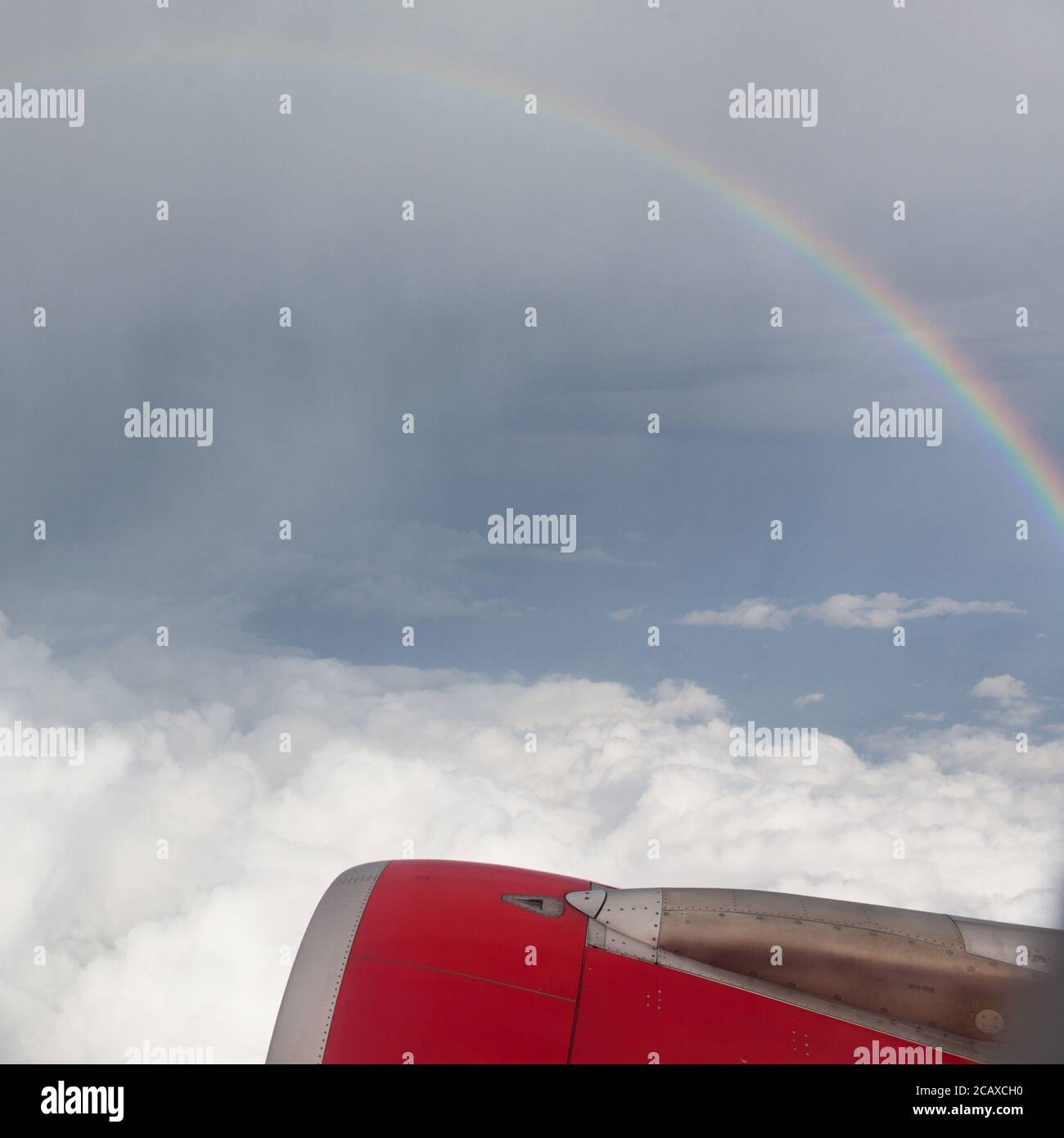 Beautiful view from airplane window and rainbow on sky during a ...