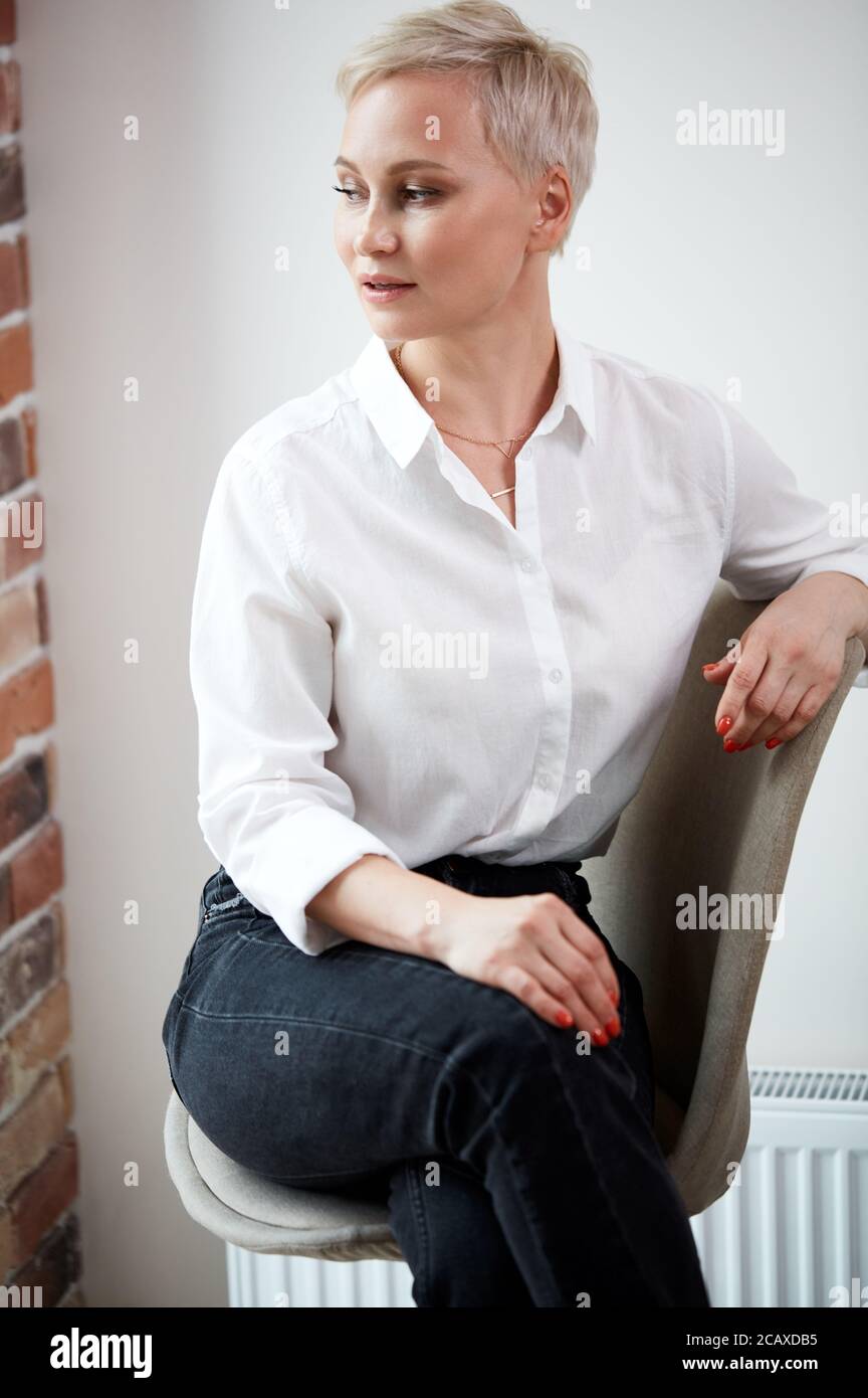 Woman sits down on chair hi-res stock photography and images - Alamy