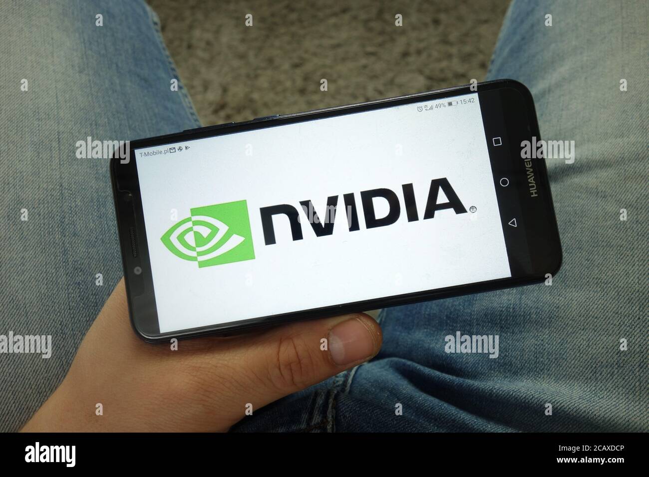 Man holding smartphone with Nvidia Corporation logo Stock Photo - Alamy