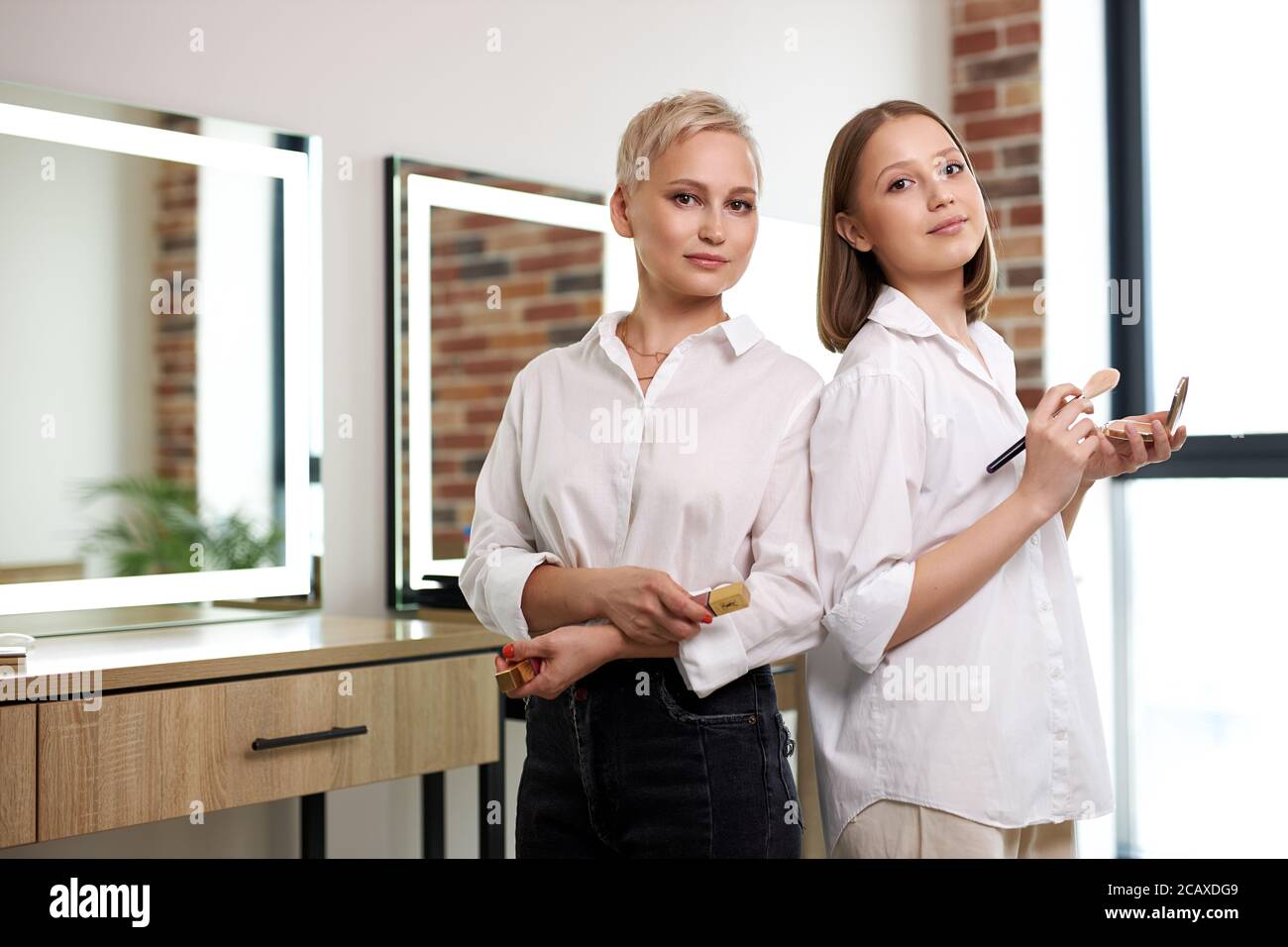 portrait of confident caucasian make-up artists in beauty studio ...