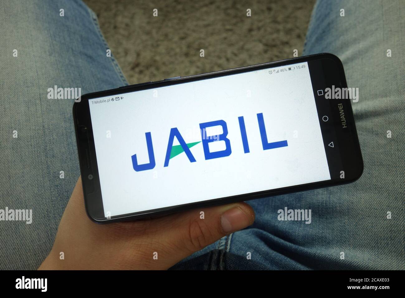 Man holding smartphone with Jabil Inc. logo Stock Photo - Alamy