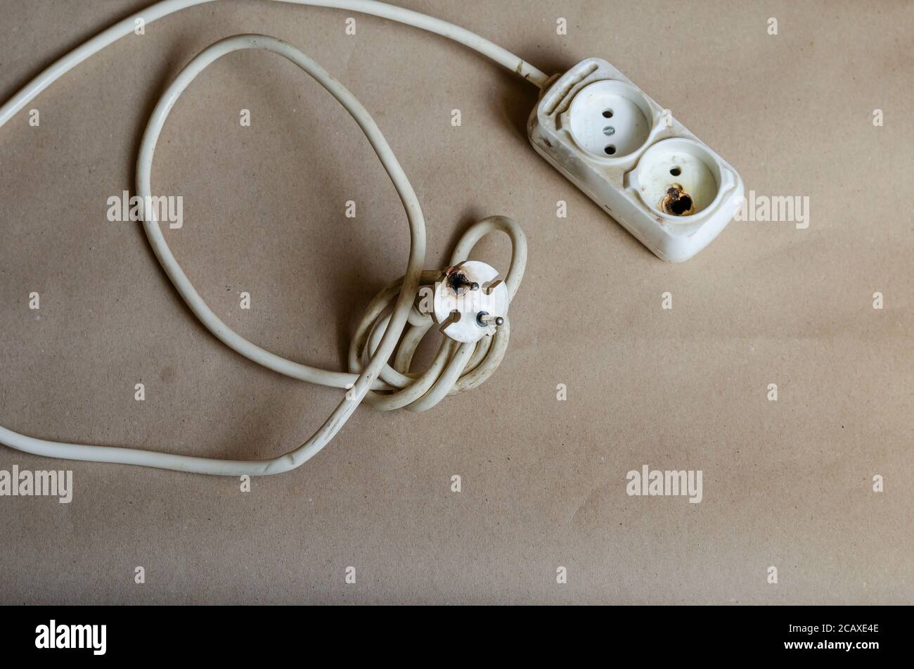 Electrical plug condition ,outlet after shock on brown background ...