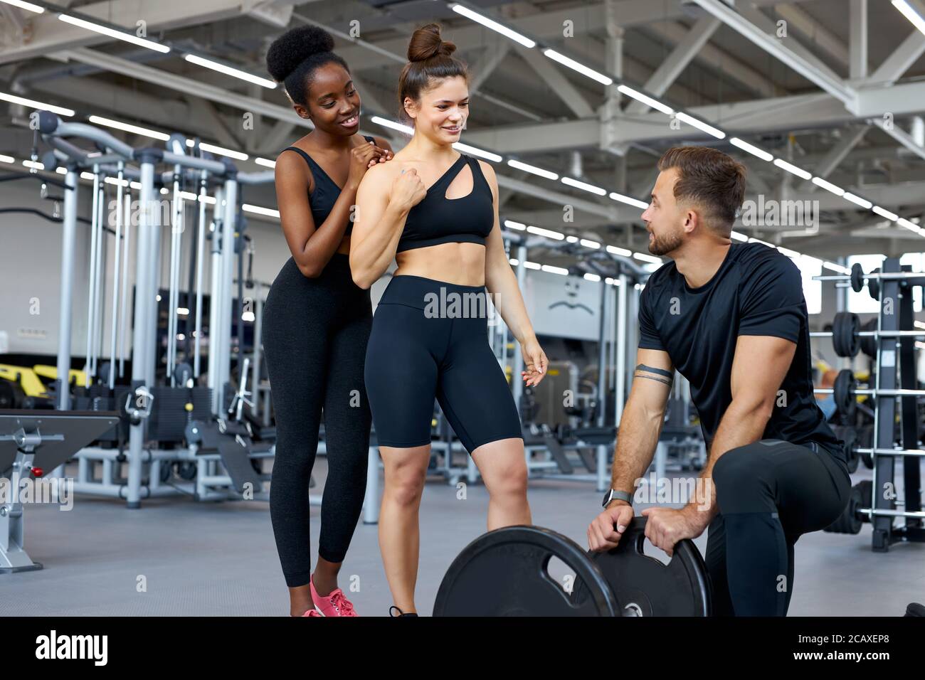 professional sportsman teach girls to pump muscles with the use of ...