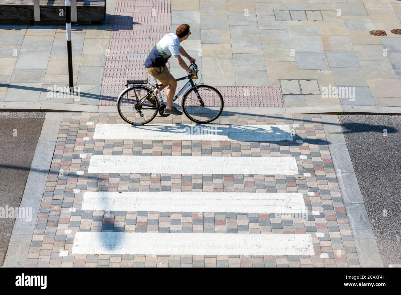 A male cyclist on a pedestrian crossing, viewed from above, King's ...