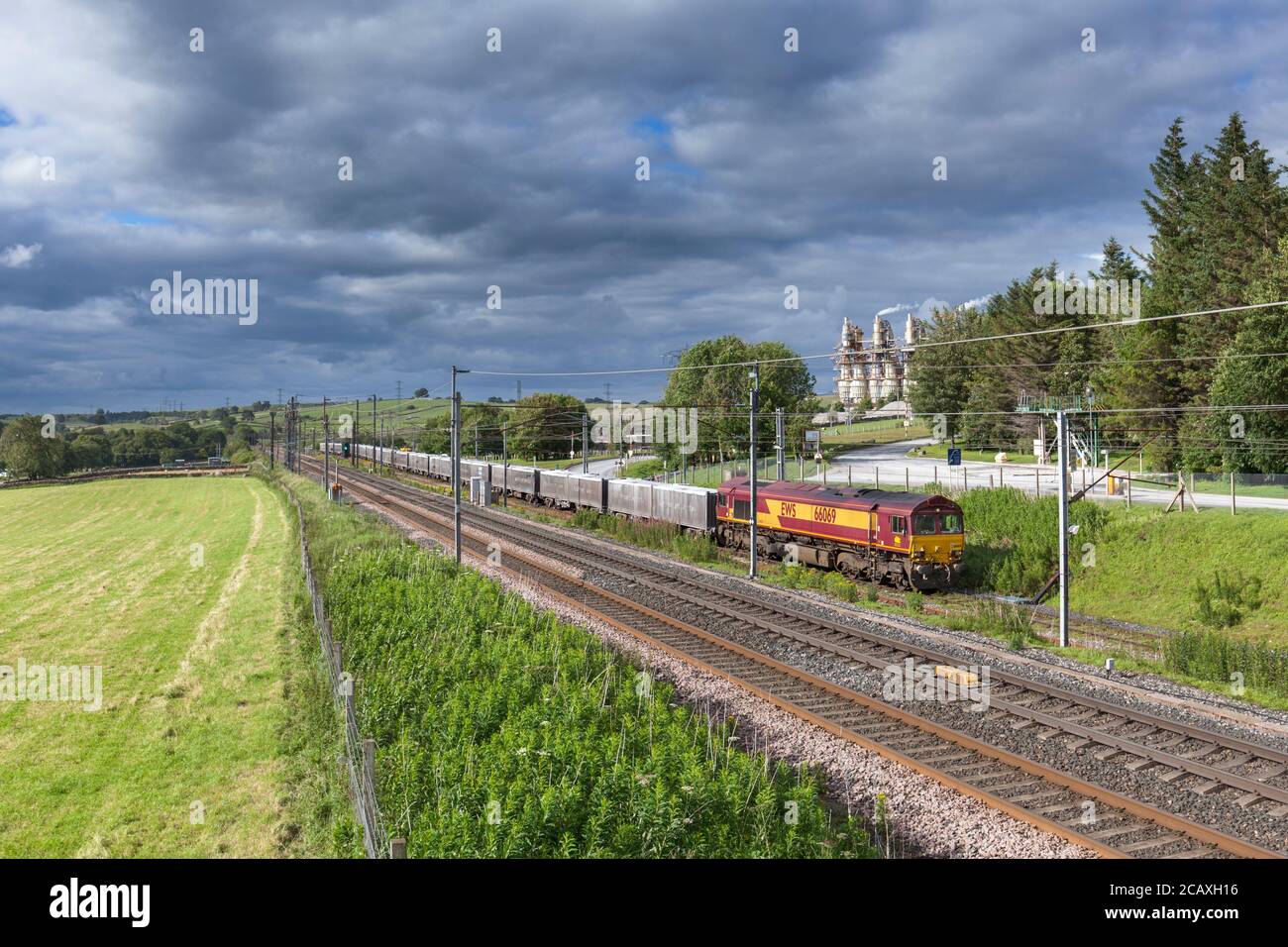 DB Cargo class 66 locomotive shunting a freight train carrying lime ...