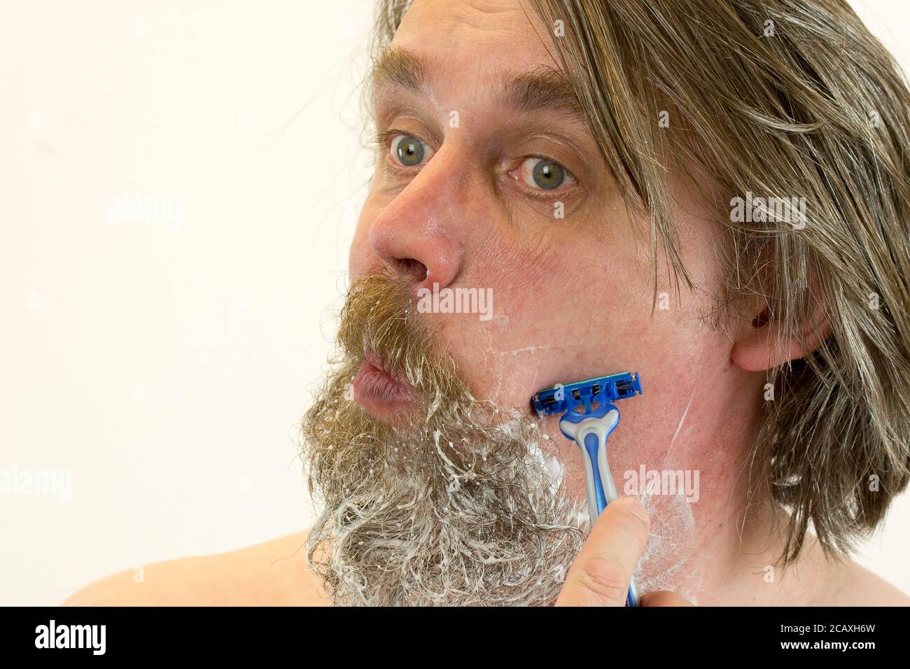 Portrait of man shaving. A variety of emotions. Cruelty and masculinity ...