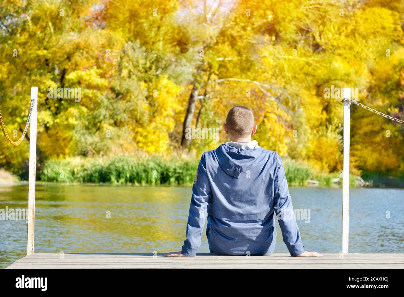 Man sitting on dock hi-res stock photography and images - Alamy