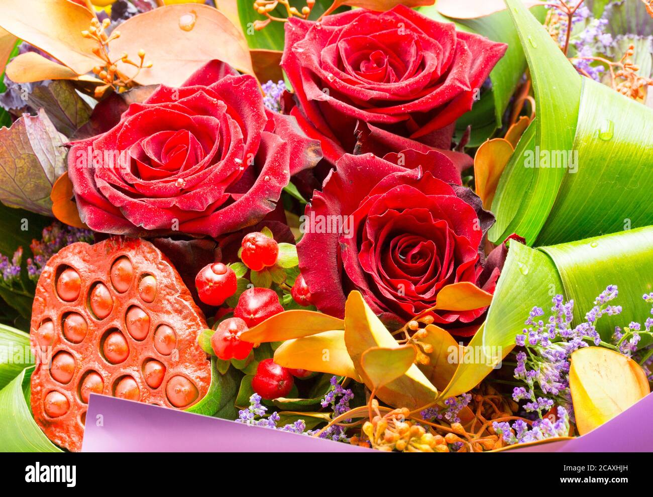Bouquet of roses and strange flowers. Beautiful bouquet of velvet red ...