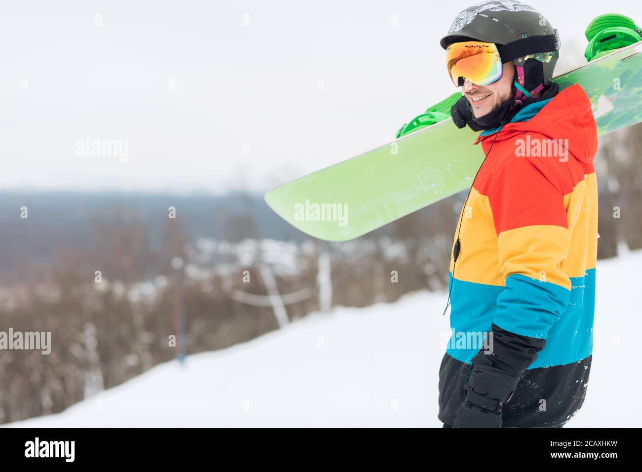 guy with positive mood preparing for snowboarding, side view photo ...