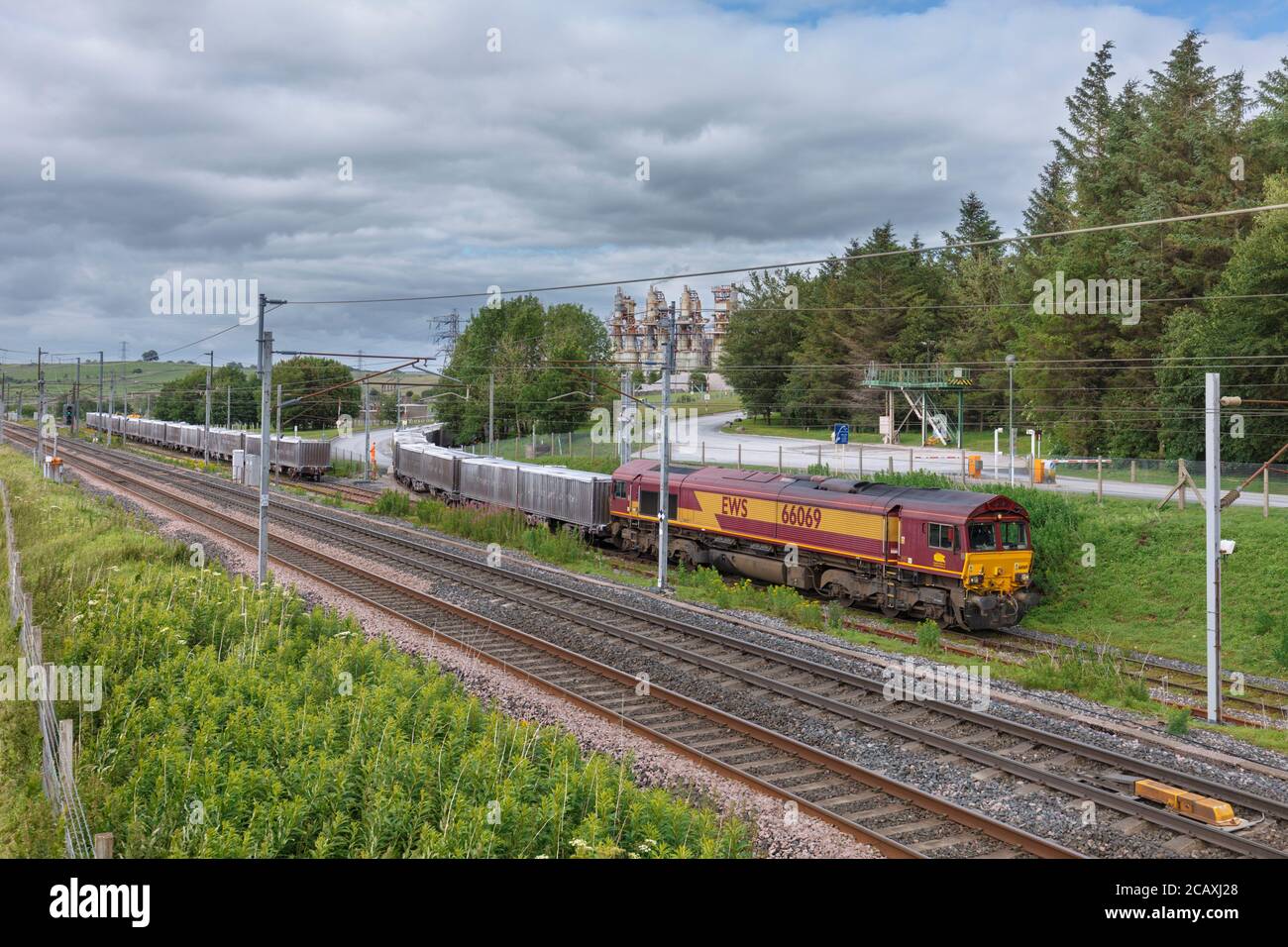 DB Cargo class 66 locomotive shunting a freight train carrying lime ...