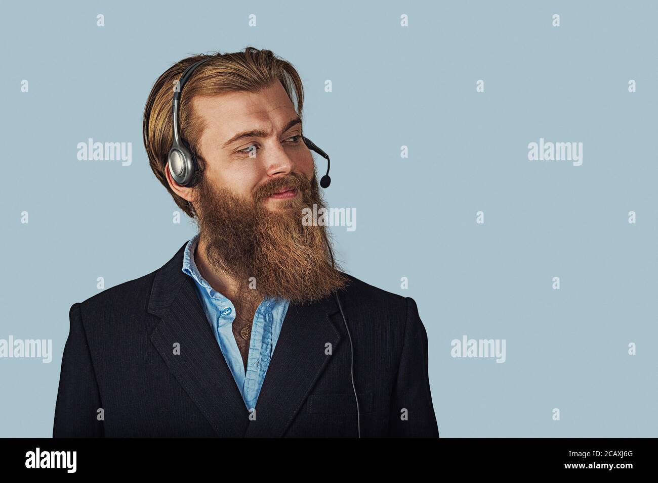 Bearded hipster businessman. Friendly customer service guy over light ...