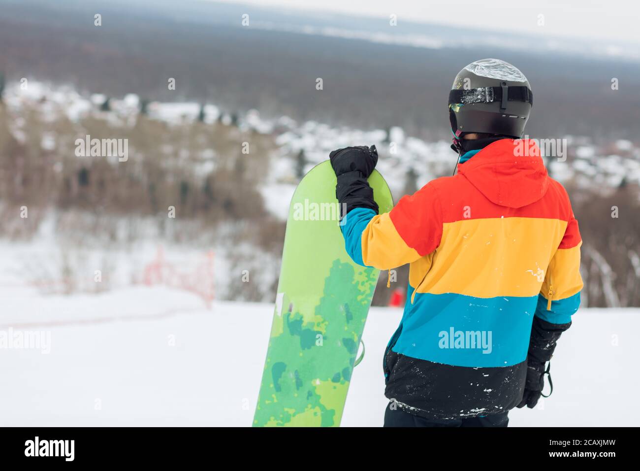 man exploring the mountain for snowboarding, back view photo Stock ...